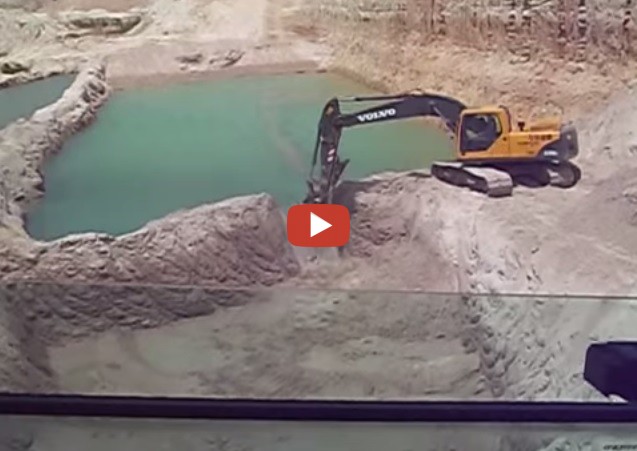 Volvo Excavator Breaks Down a Small Dam