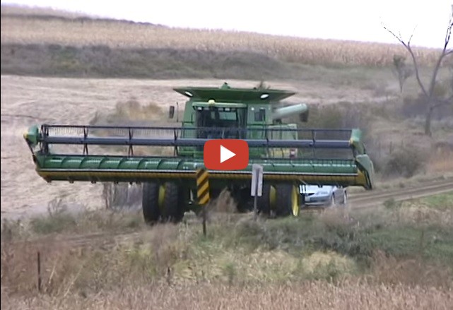 John Deere Combine doing some tricky maneuvering down the road
