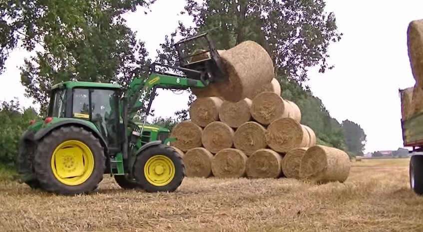 Unload round bales.