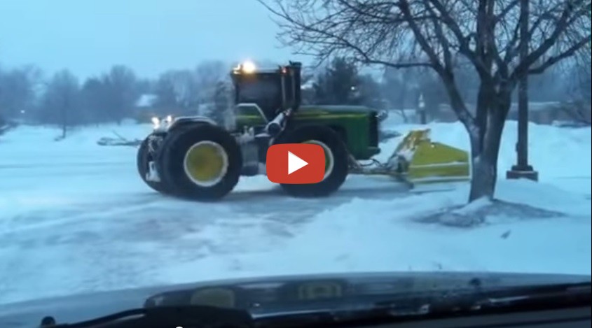 Giant John Deere Tractor Snow Plow Stuck and Spinning On the Ice.