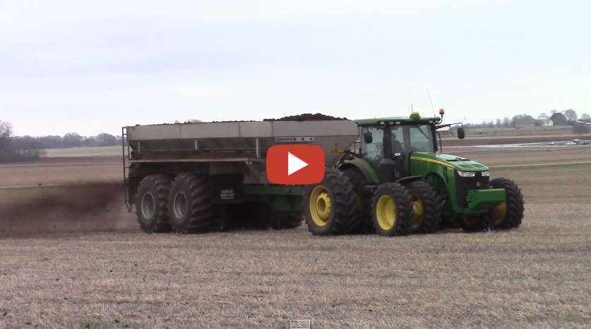 John Deere 8360R tractor spreading chicken manure with a Chandler spreader. (bigtractorpower)