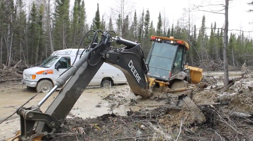 Big Backhoe Stuck in Deep Mud and Water