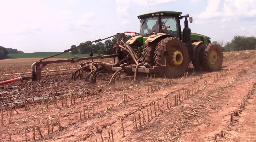 John Deere 8370R Tractor with a manure plow applying manure following ...