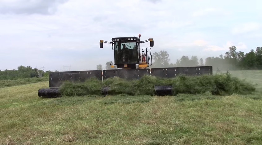Oxbo's 4334 Self-Propelled Merger combines seven swaths of cut hay ...