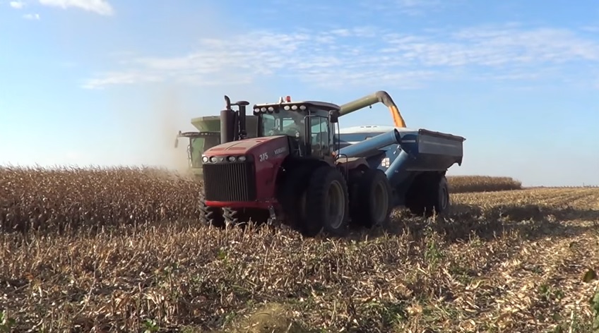 John Deere S690 combine with a 12 row corn head harvesting corn with a ...