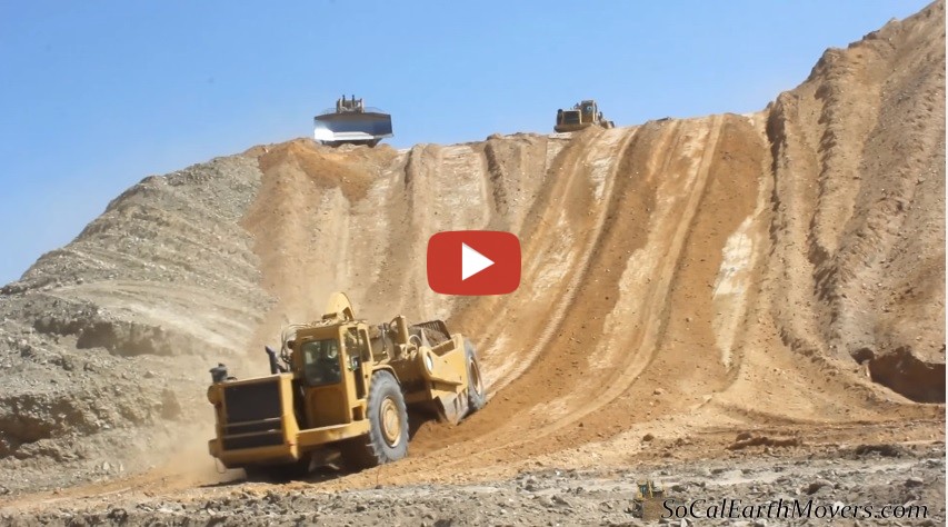 ROCKFORCE CAT 651B's push loaded off hilltop