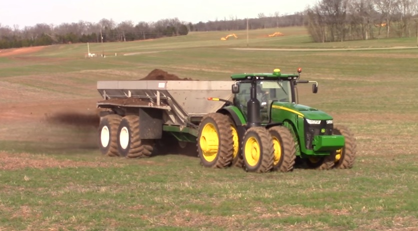 John Deere 8345R and a Chandler Poultry Litter Spreader spreading chicken litter ahead of 2016 ...