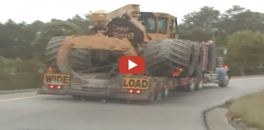 Bobby Goodson Swamp Loggers hauling their 6 wheeled skidder-Road Hammer