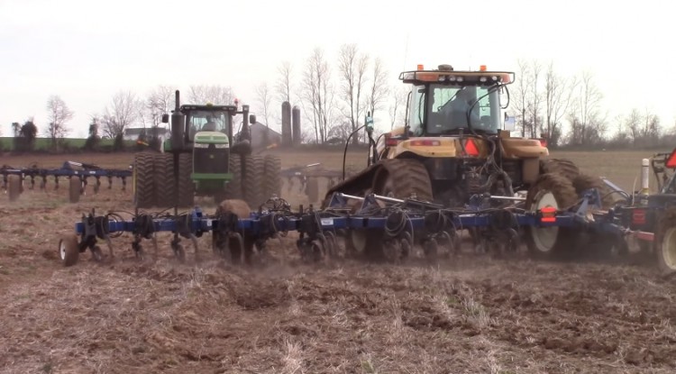 A Challenger MT875C is bogged down in the mud pulling a 60ft Blu-Jet AT ...