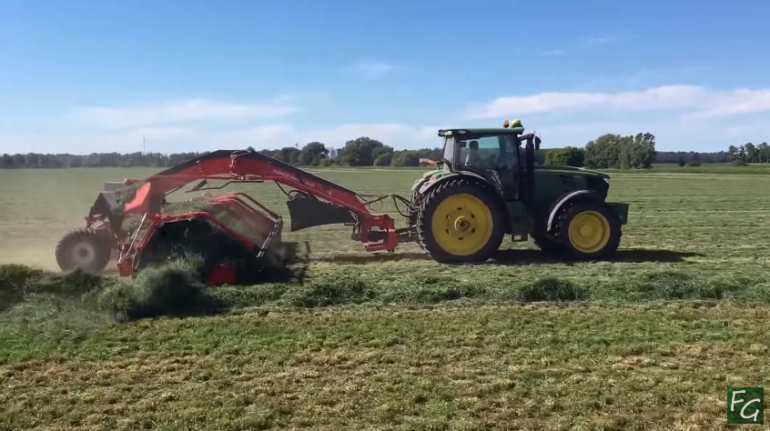John Deere 6R Merging Hay Silage With Kuhn Maxx 900 -- TheFarmingGuys