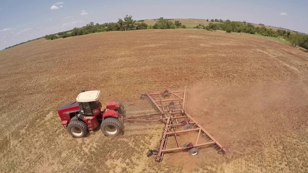 Two Versatile 340 tractors pulling disks in the same wheat fields near ...