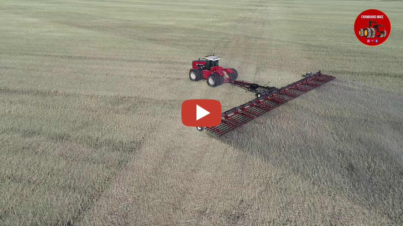 Versatile 575 Tractor pulling a 90 foot wide Elmers Super 7 Harrow in a ...