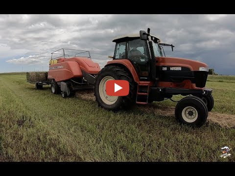 Versatile 2145 tractor and baler working in the field near Calgary ...