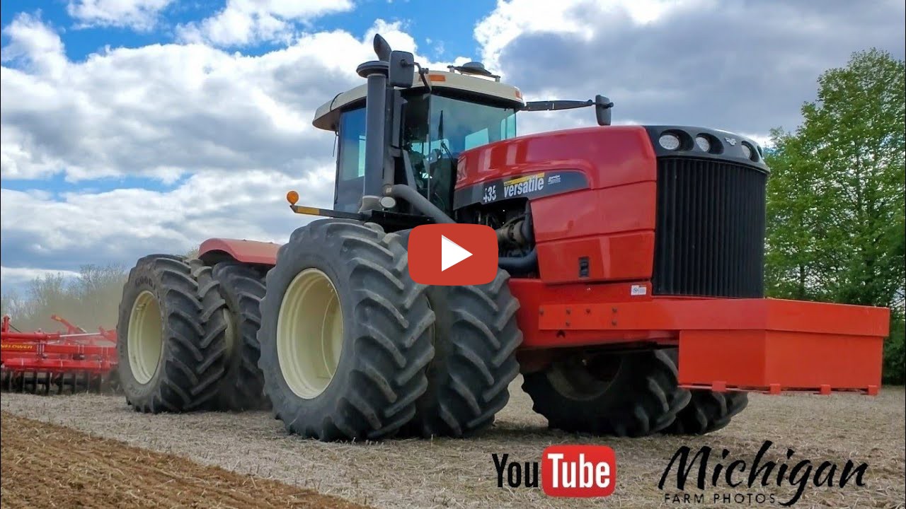Versatile 435 pulling a Sunflower 6333 Soil Finisher and packer working ...