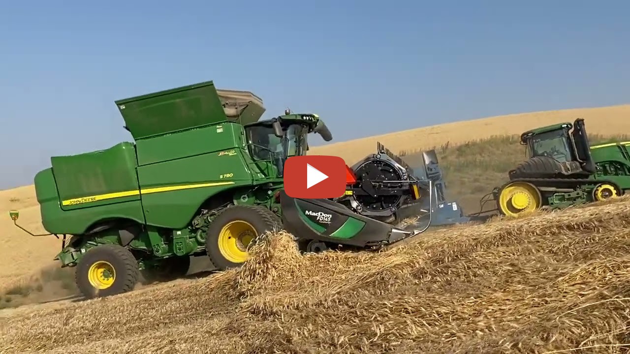 John Deere S 780 combine on hillside closeup. 2022 A combine goes past ...